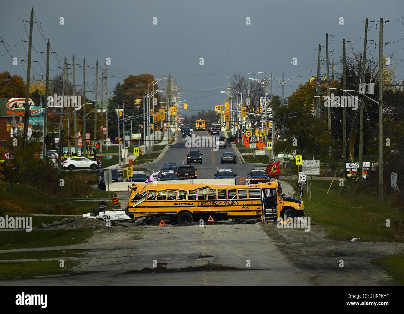 A school bus blocks the roadway which is near a construction site at ...