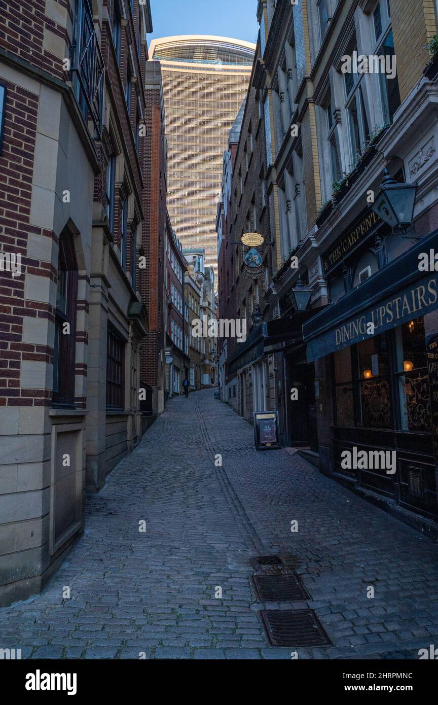 Vertical of an empty narrow corridor between buildings near Fenchurch ...