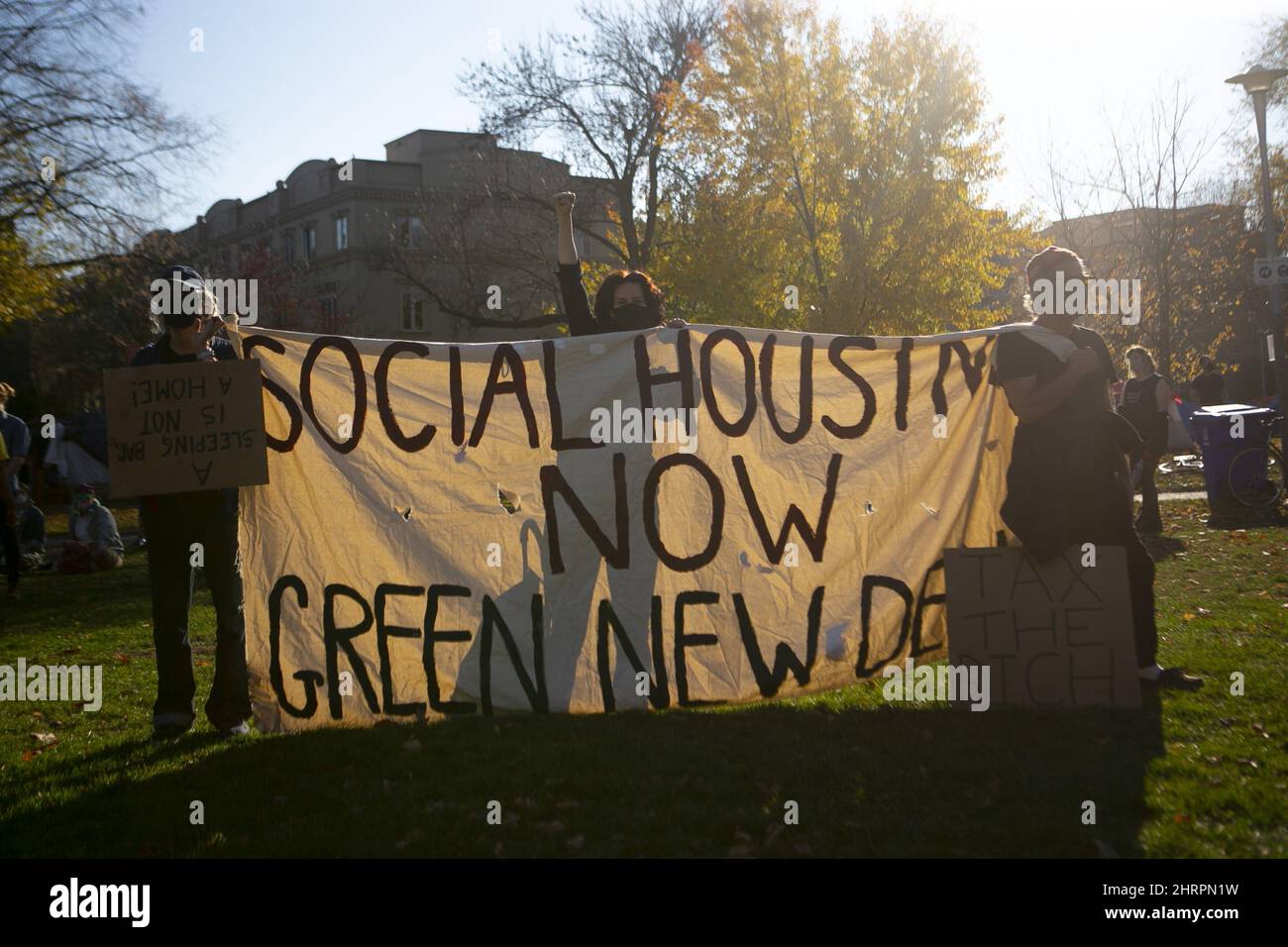 Supporters hold a banner at a protest at an homeless encampment in ...