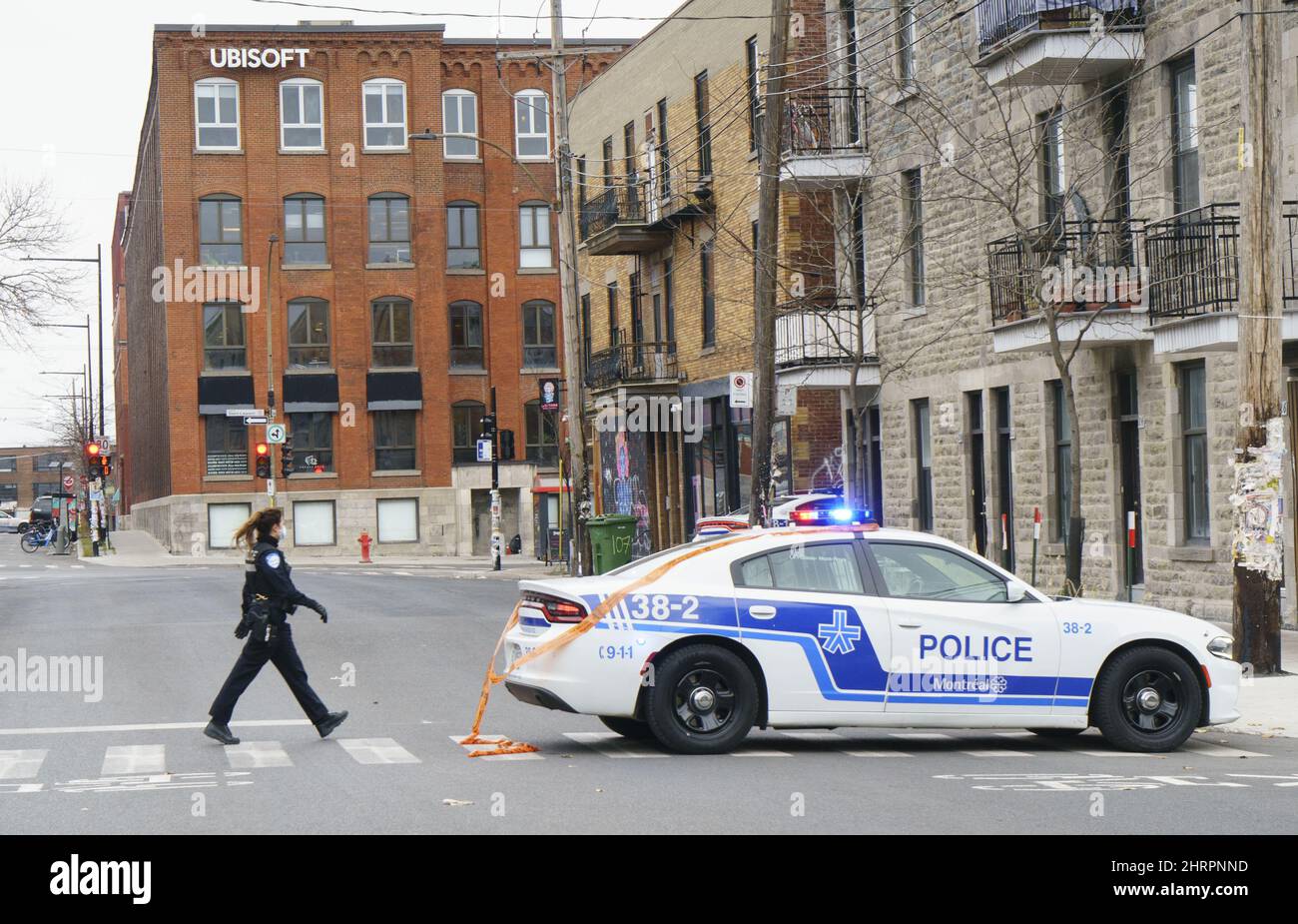 A police officer walks towards a police vehicle as a perimeter is set ...