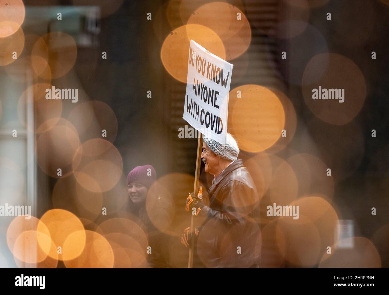 A man walking to a protest arranged by people opposed to COVID-19 ...