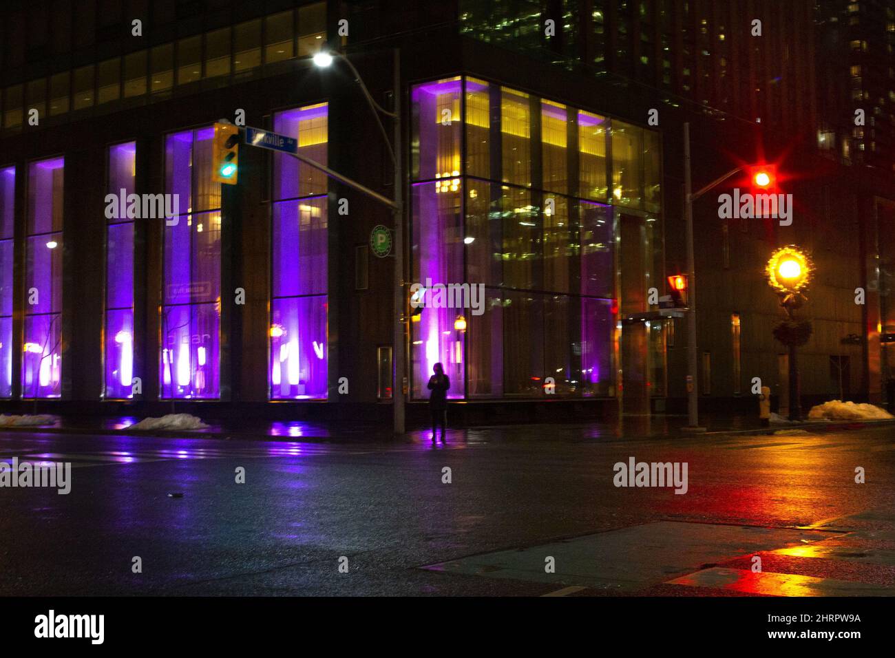 A lone pedestrian waits to cross an intersection in downtown Toronto on ...