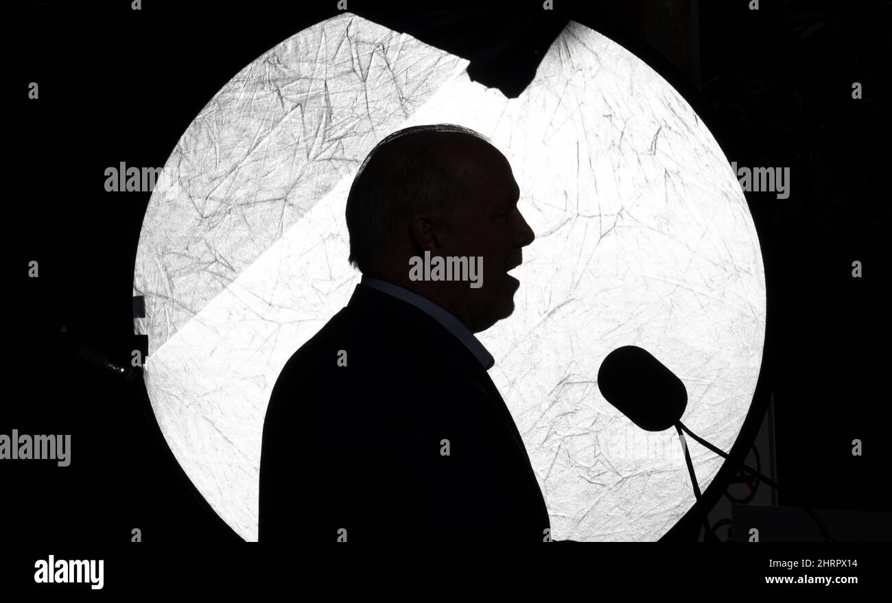 NDP Leader John Horgan is silhouetted against a reflector as he ...