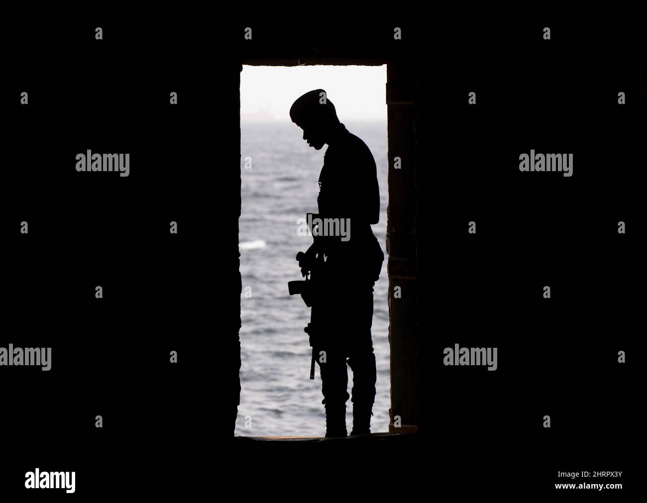 A Sengal Police Officer stands in the 'Door of No Return' at the slave ...