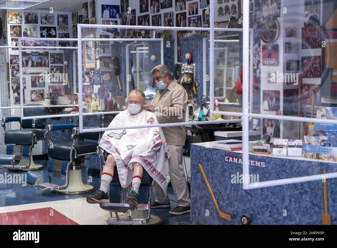 Barber Menick, who has been cutting hair for 61 years, cuts a customer ...