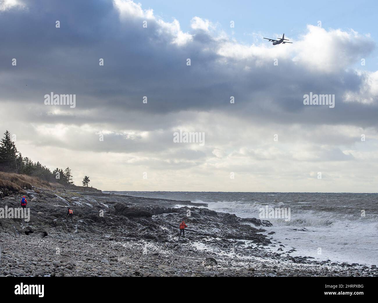 An RCAF Hercules aircraft scours the waters as members of a ground ...