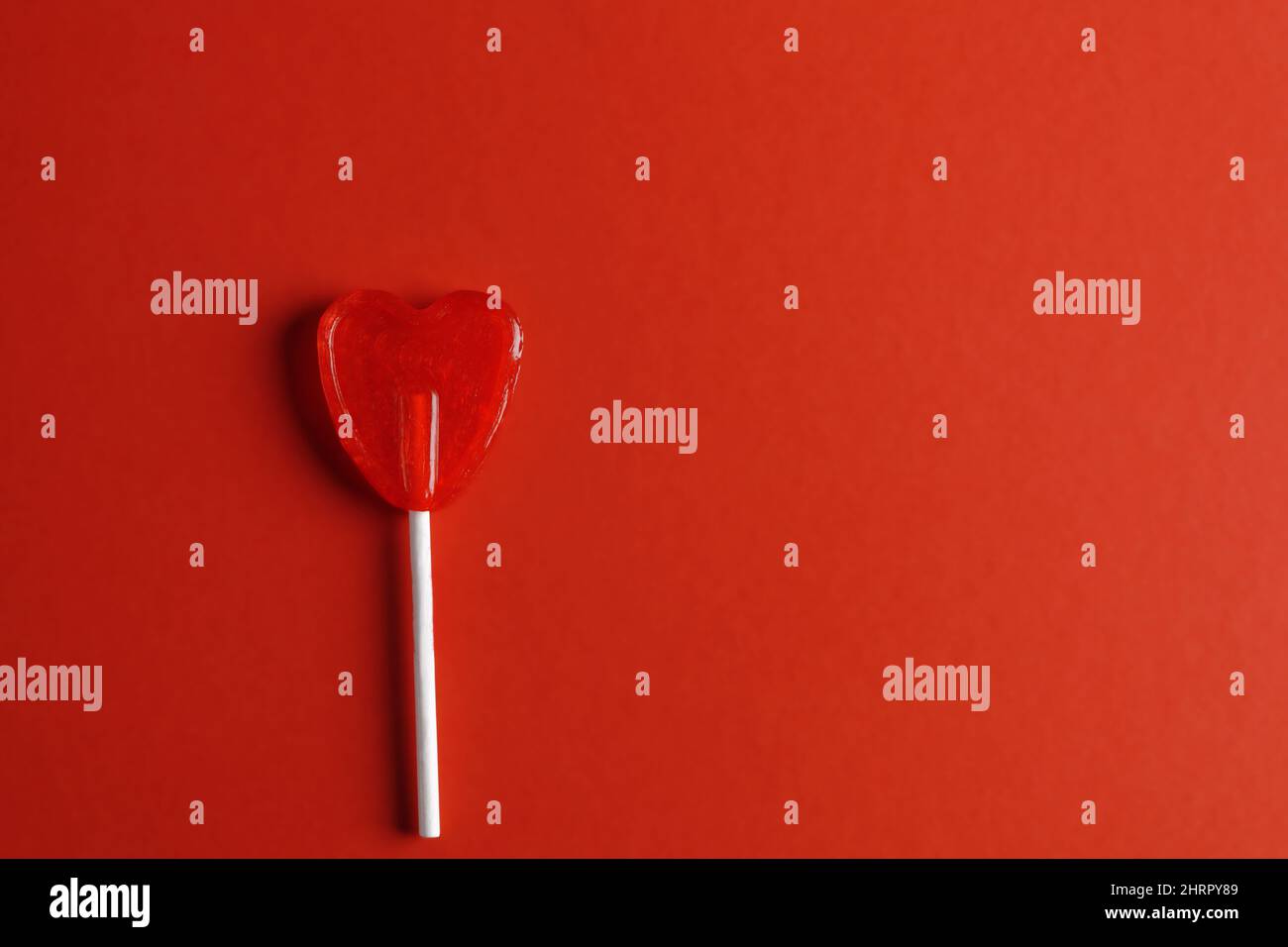 Flat lay of a heart lollipop on red background with copy space. Great ...