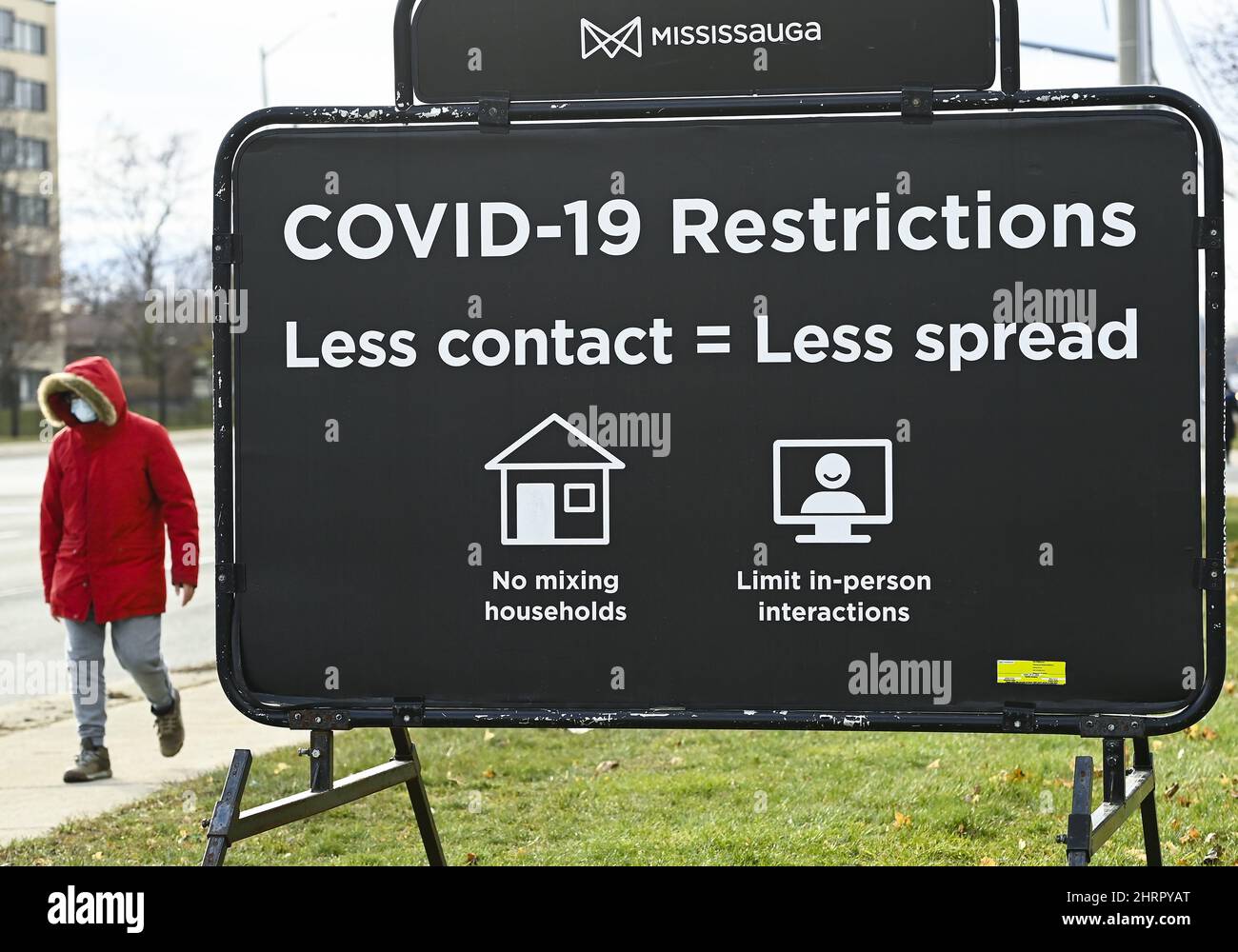 A person walks past a COVID-19 restrictions sign during the COVID-19 ...