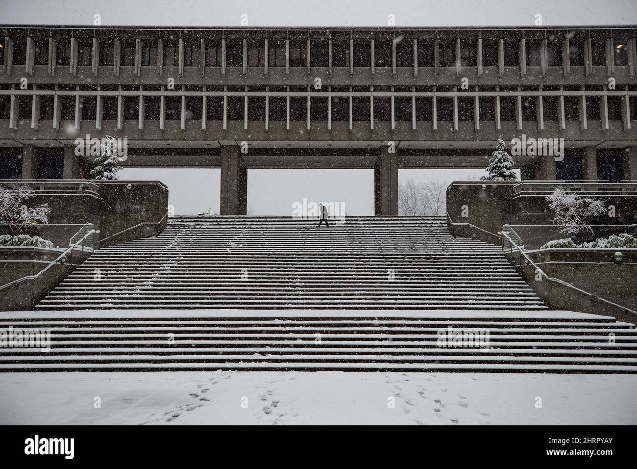Heavy snow falls as a man walks down steps on the Simon Fraser ...