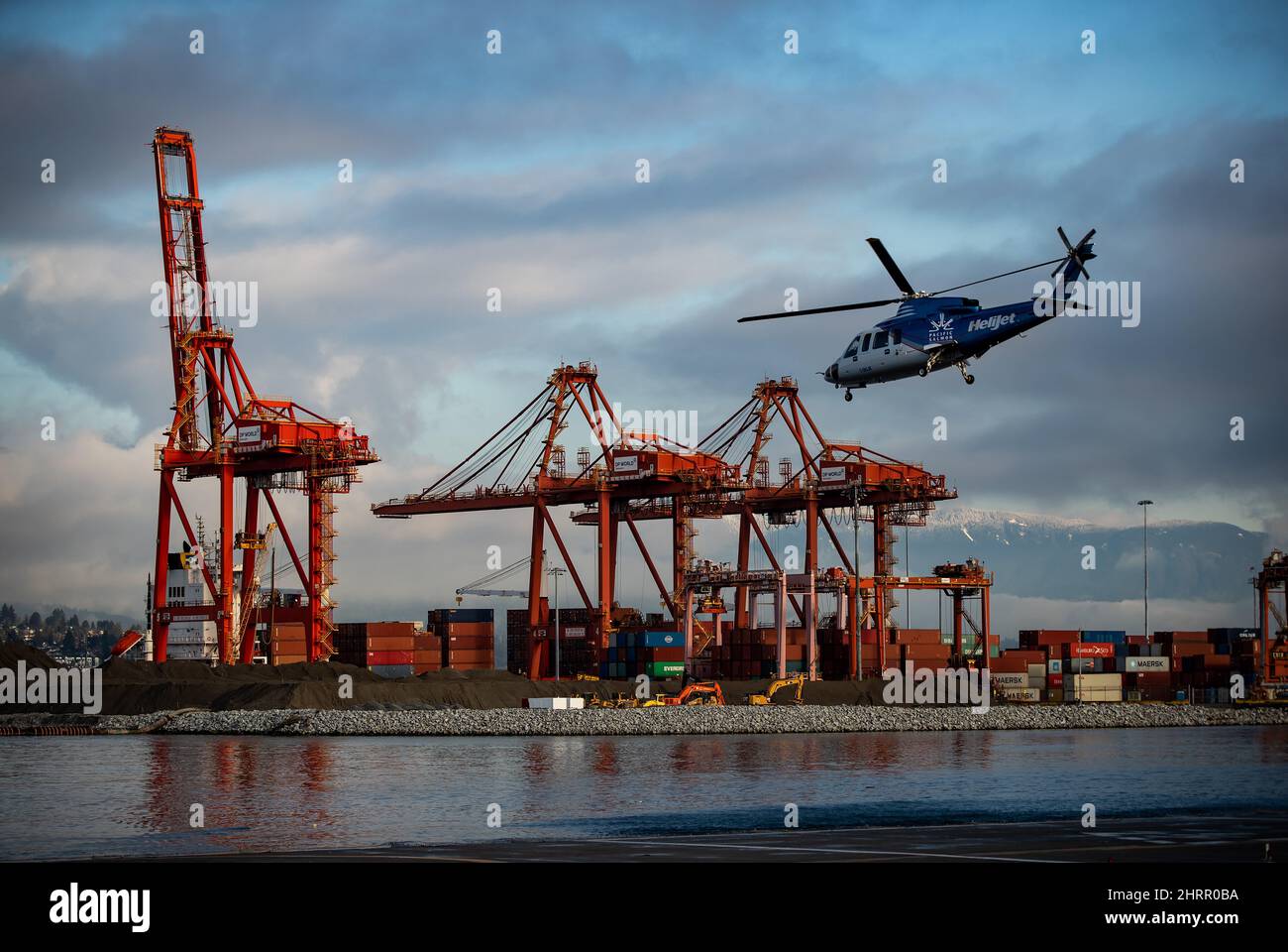 A Helijet passenger helicopter lifts off from a helipad on the harbour ...
