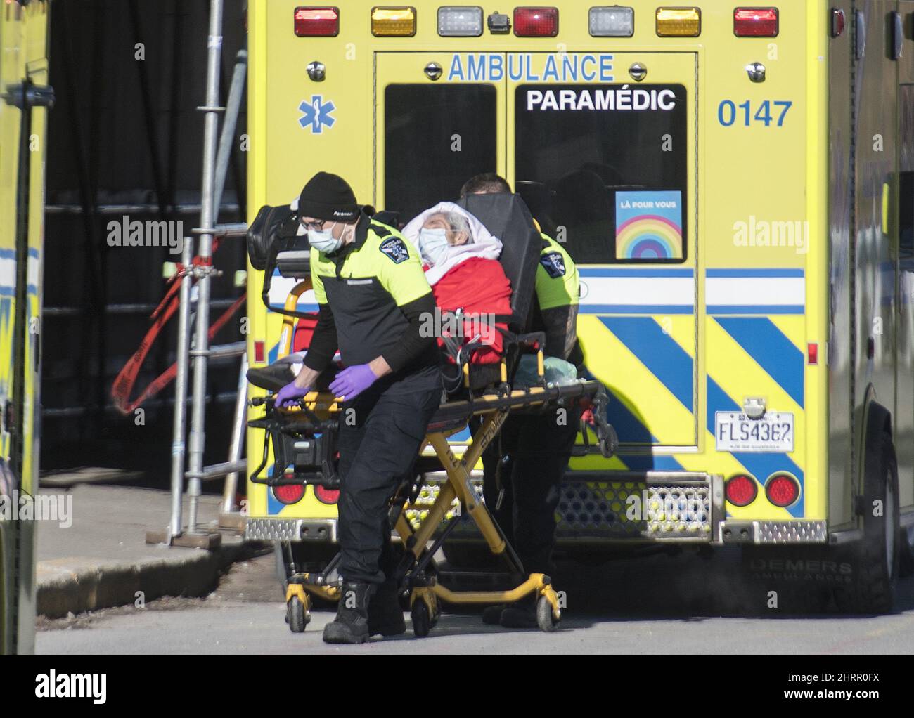Paramedics transfer a person from an ambulance into Verdun Hospital in ...