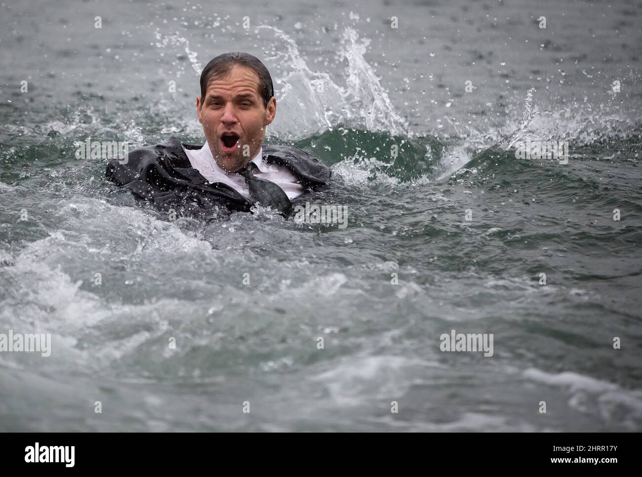Jason Rude wears a suit and tie as he plunges into the water at English ...
