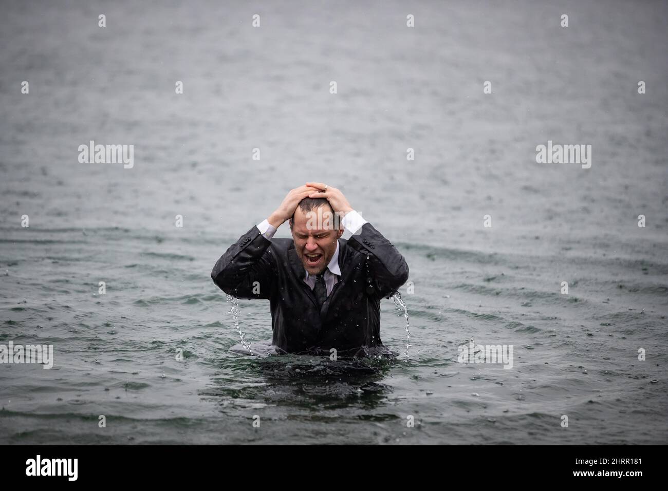 Jason Rude wears a suit and tie as he plunges into the water at English ...