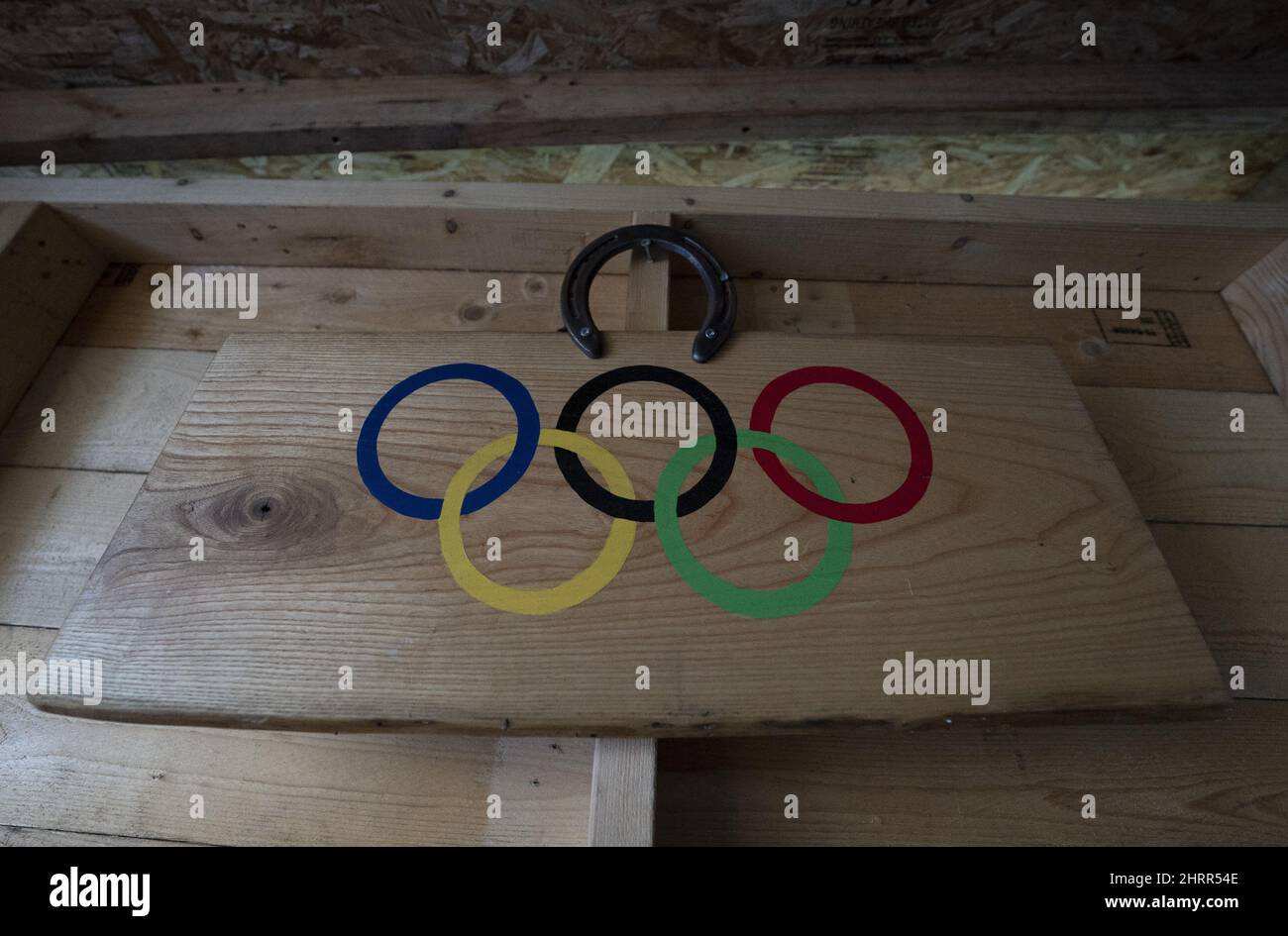 The Olympic rings and a horseshoe are pictured on the wall where ...