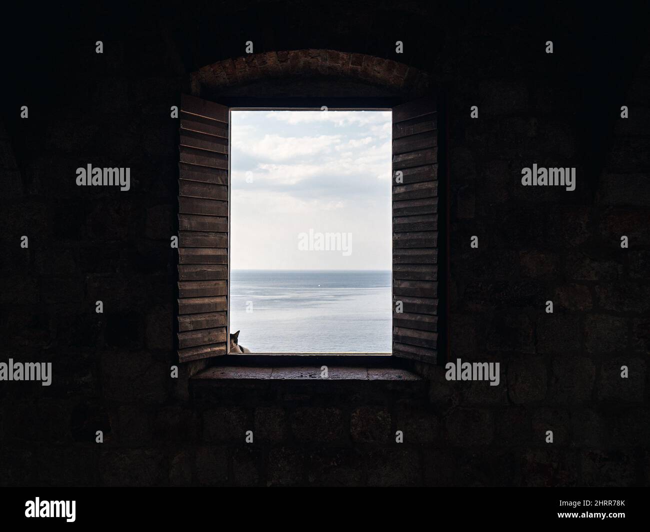 View of a sea from a window in a dark room Stock Photo - Alamy