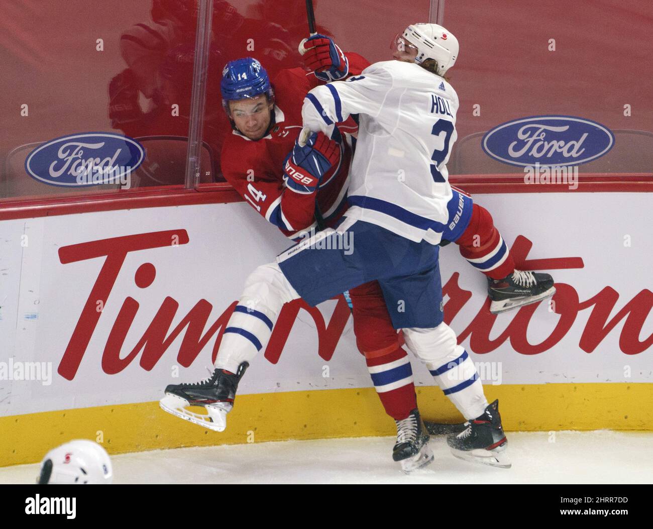 Montreal Canadiens' Nick Suzuki takes a hit from Toronto Maple Leafs ...