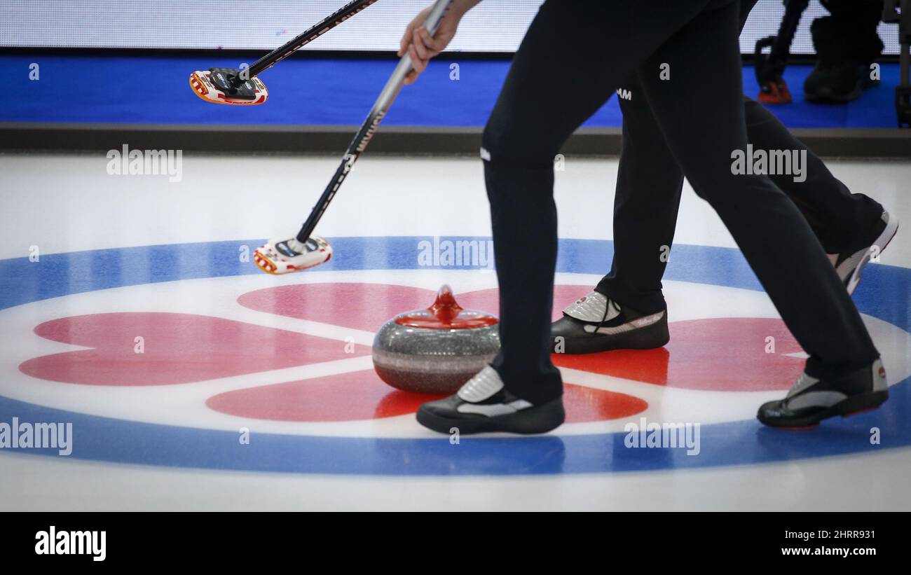 Sweepers follow a rock at the Scotties Tournament of Hearts in Calgary ...
