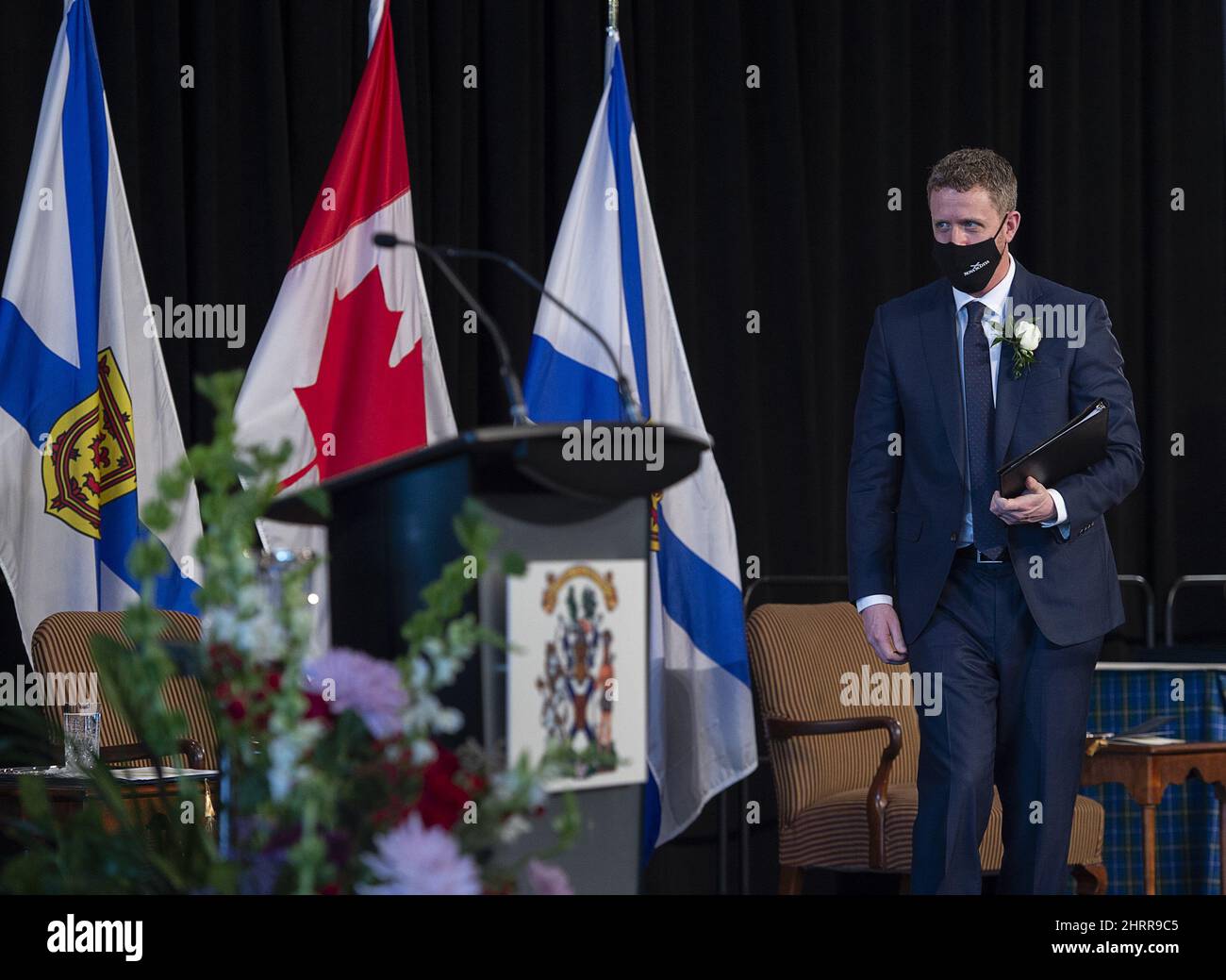 Nova Scotia Premier Iain Rankin heads to address the audience after ...