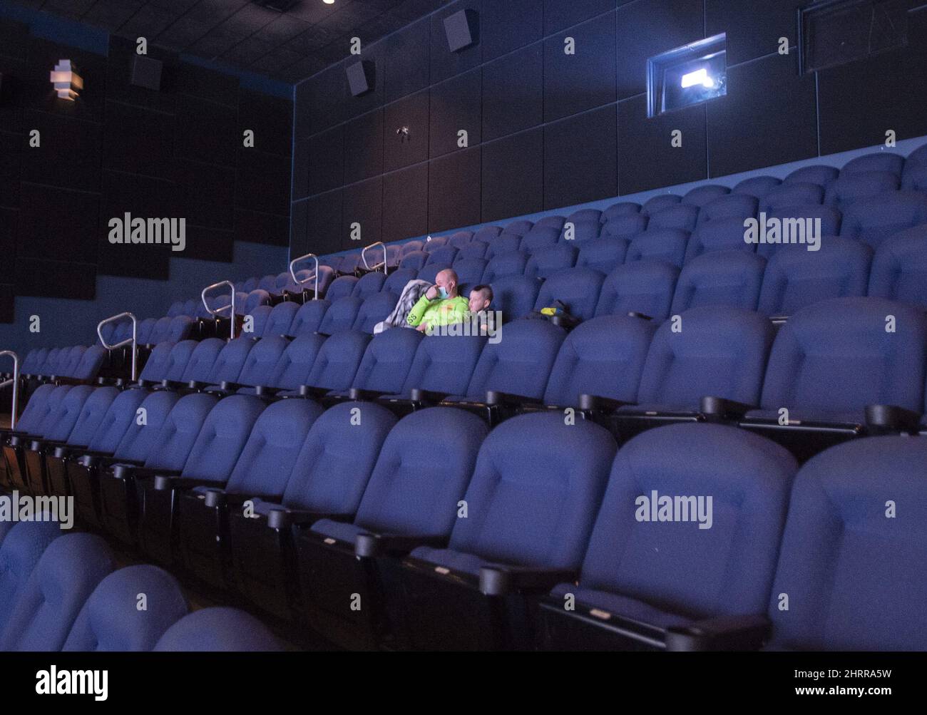 A few customers watch a movie at a Cineplex movie theatre as cinemas in ...