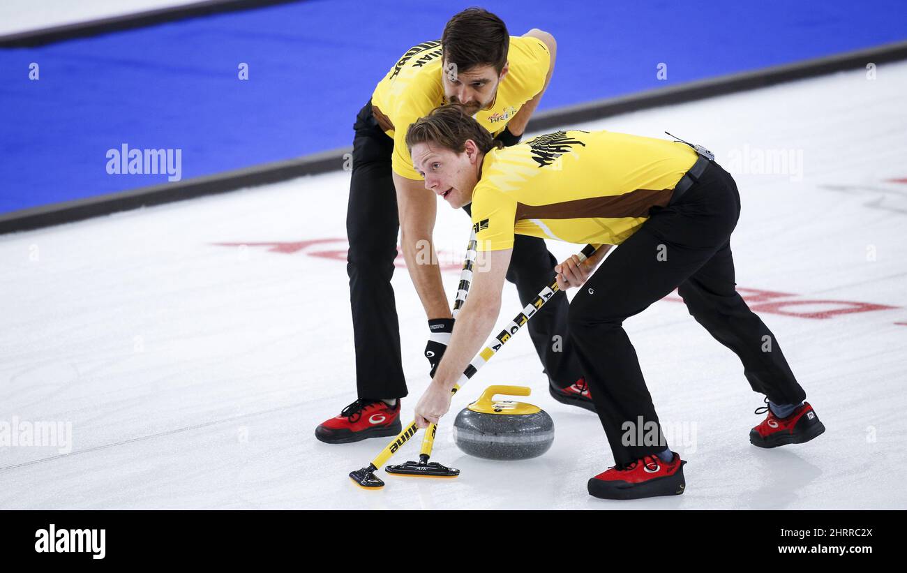 Team Manitoba second Matt Wozniak, top, and third Adam Casey sweep as ...