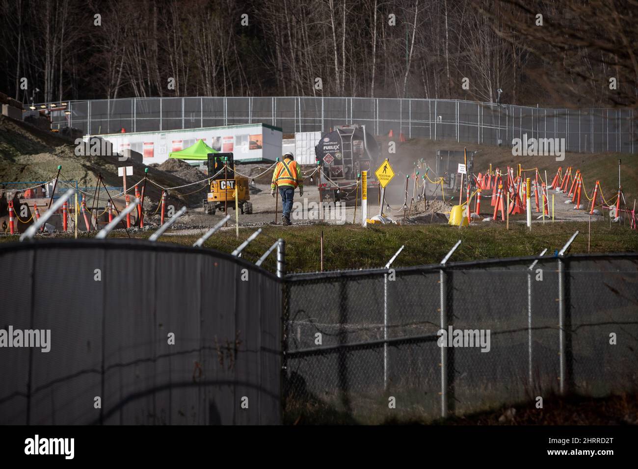 A construction worker walks through the site as work continues on the ...