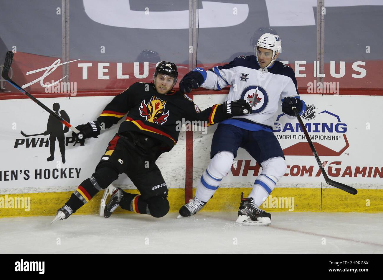 Calgary Flames' Sam Bennett, left, collides with Winnipeg Jets' Dylan ...