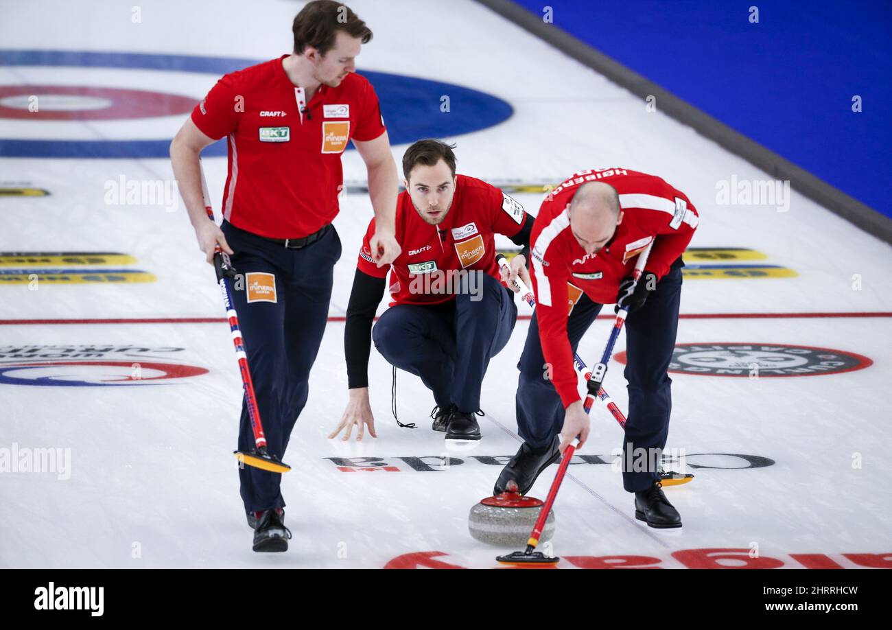 Norway skip Steffen Walstad, centre, makes a shot as second Markus ...