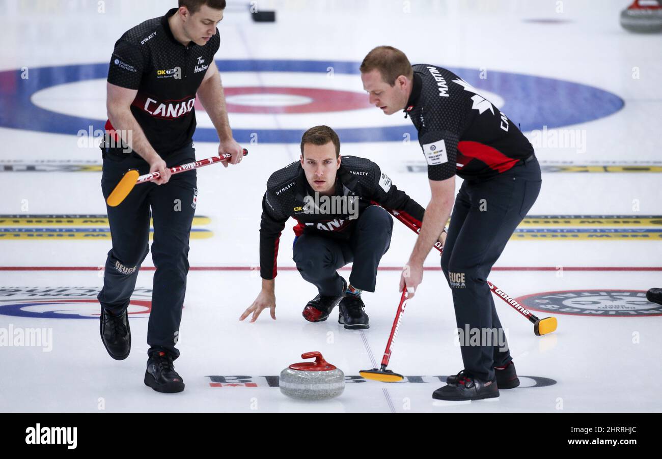 Team Canada skip Brendan Bottcher, centre, makes a shot as lead Karrick ...