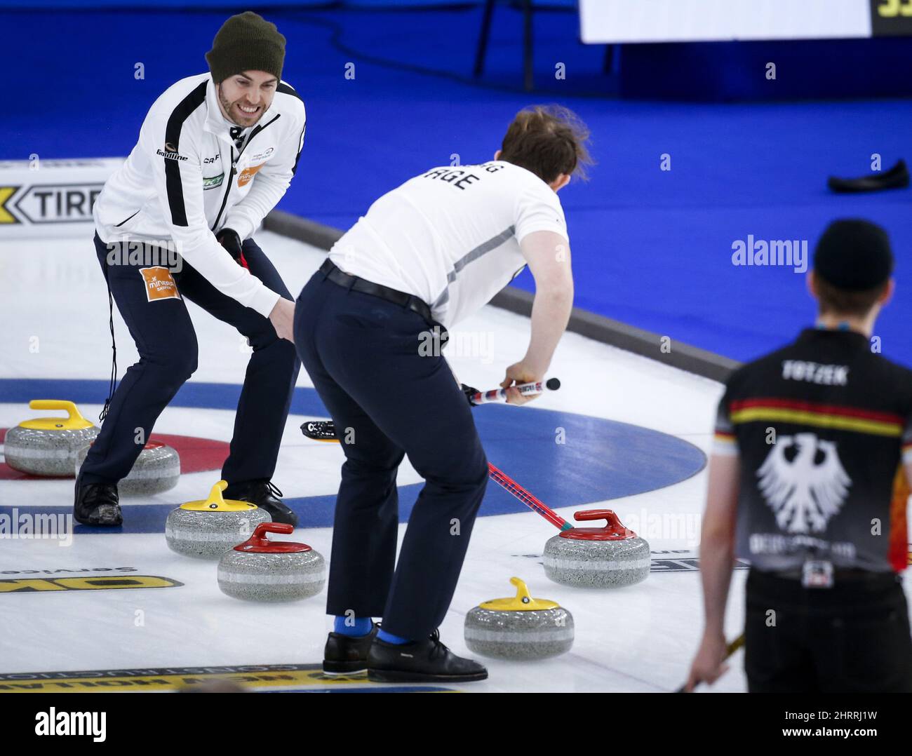 Norway skip Steffen Walstad, left, gestures to his teammate second ...