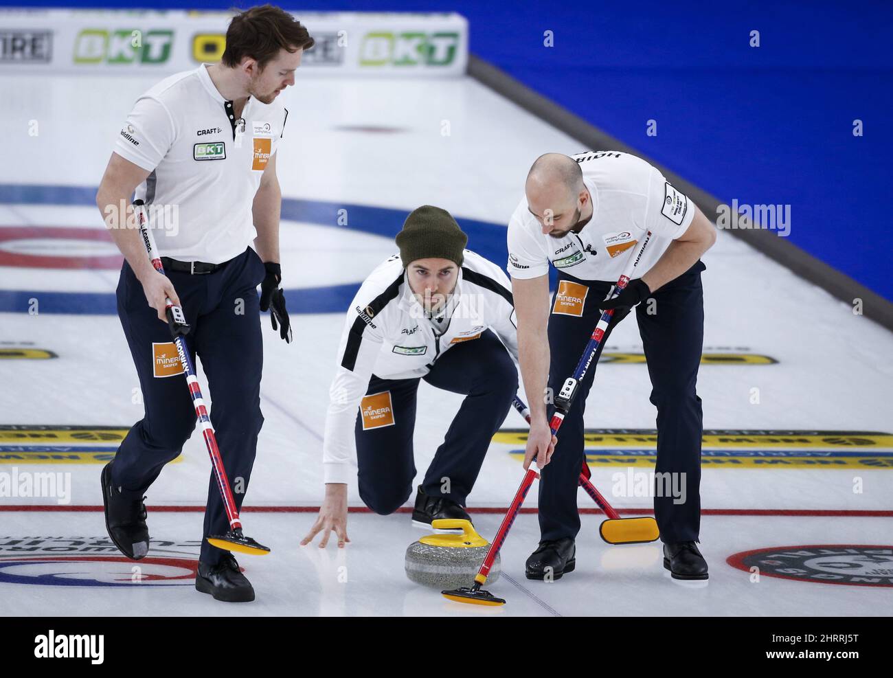Norway skip Steffen Walstad, centre, makes a shot as second Markus ...