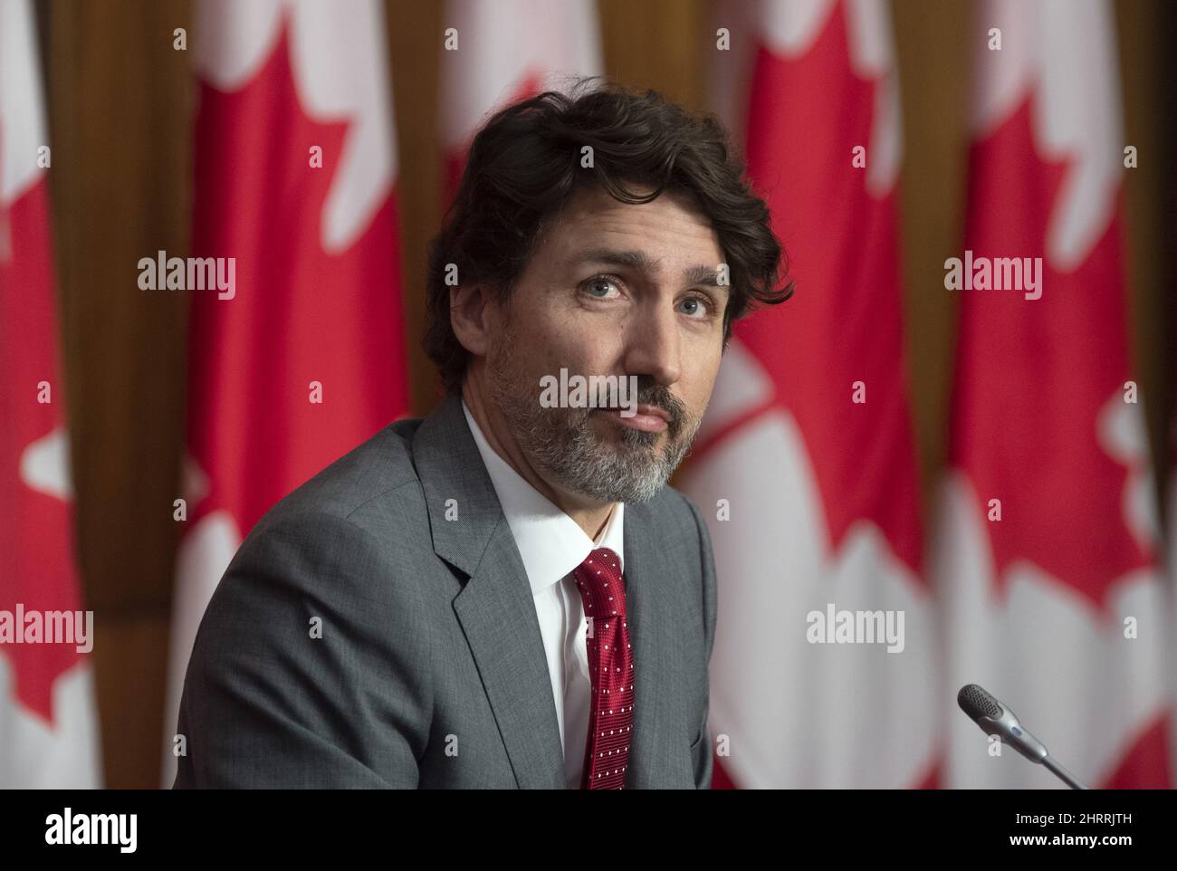 Prime Minister Justin Trudeau watches a speaker appear by ...
