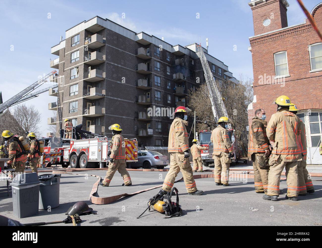 Firefighters are shown at the scene of a fire at an apartment building ...