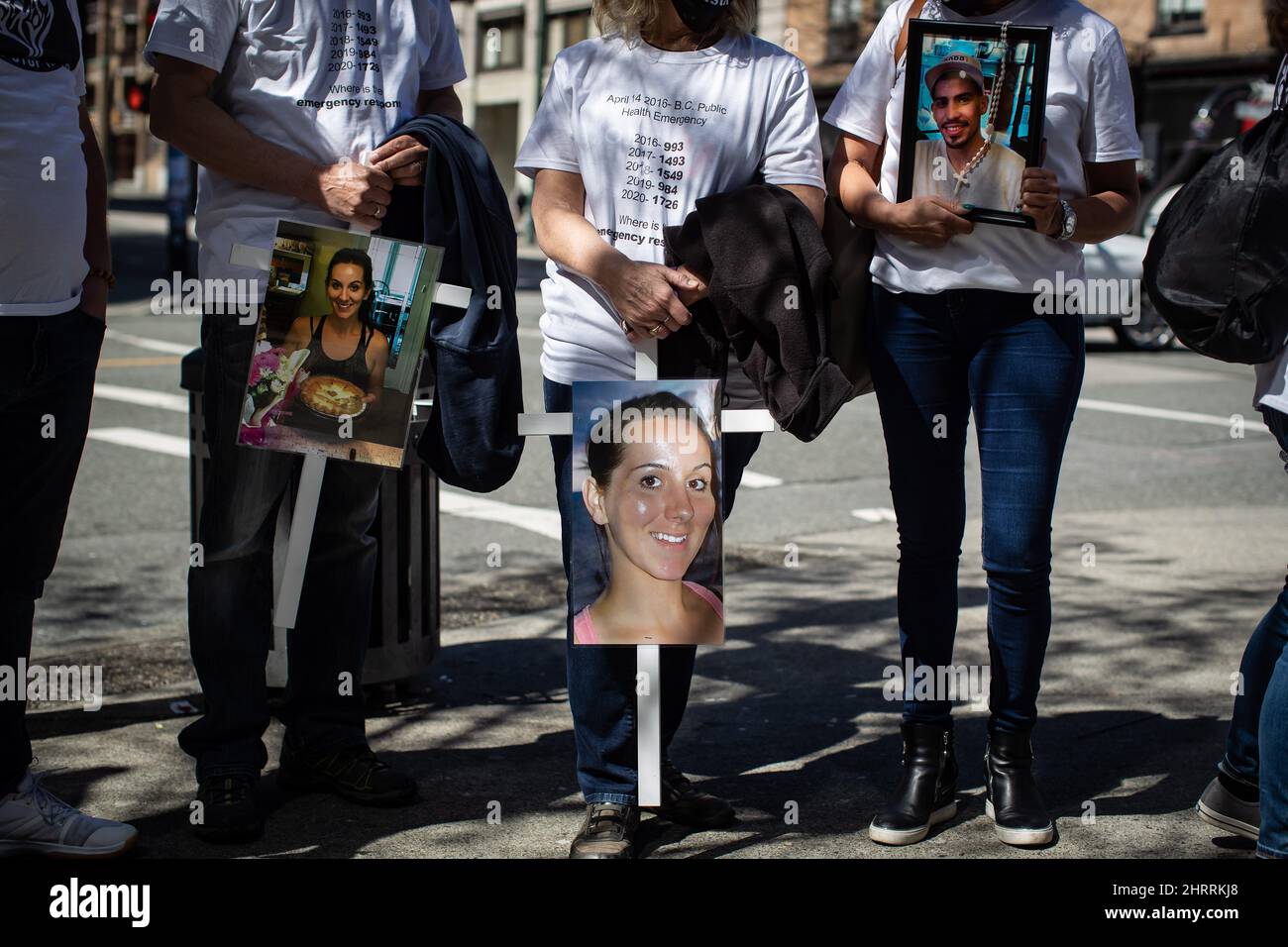 Stuart Bedard, left, and Lisa Weih, centre, hold photographs of their ...