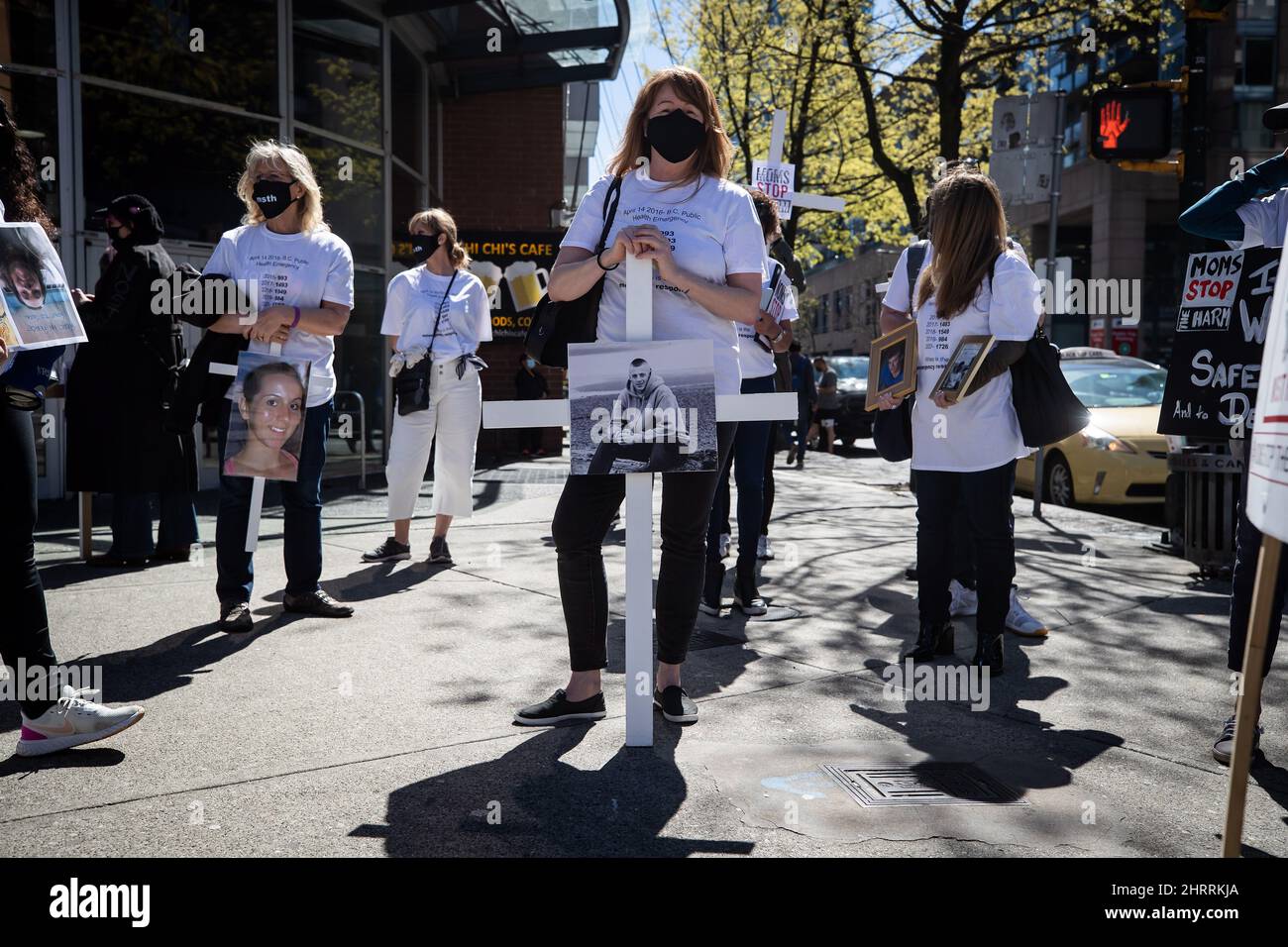 Annie Storey, centre, holds a cross with a photo of her late son Alex ...
