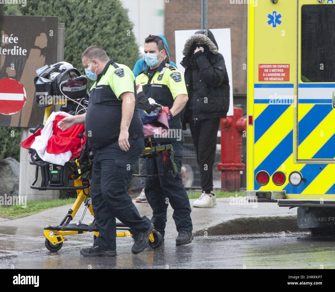 Ambulance workers transport a patient to the emergency ward at Verdun ...
