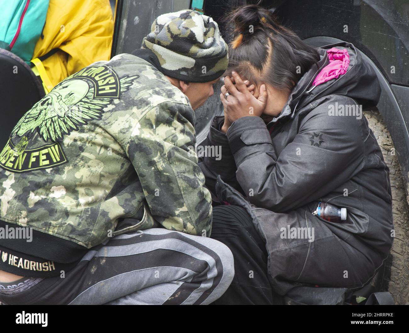 People comfort each other at a homeless camp in the east end of ...