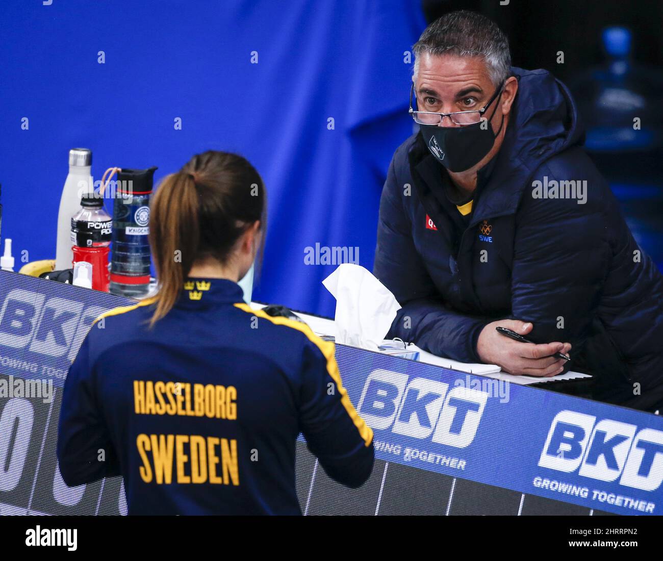 Sweden skip Anna Hasselborg, left, speaks with coach Wayne Middaugh as ...