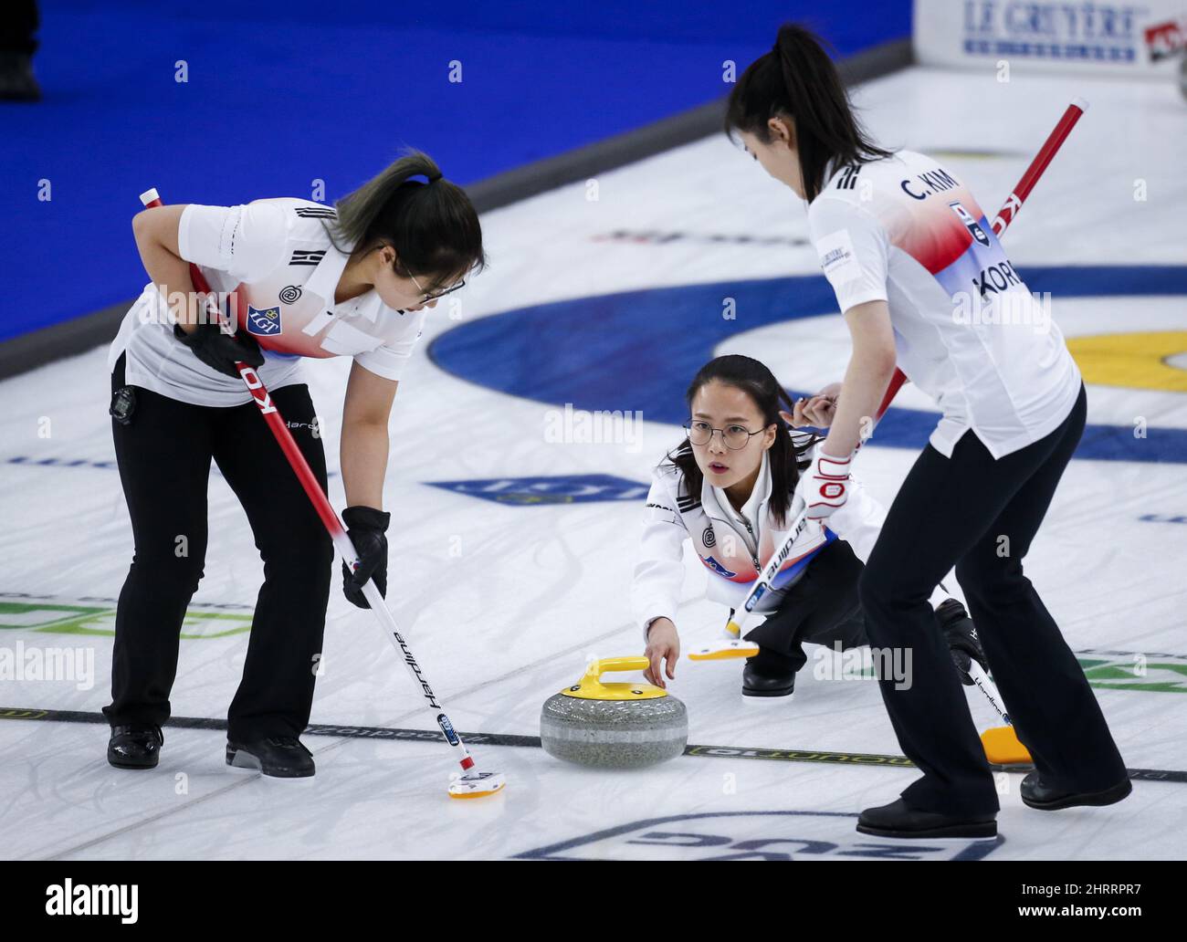 South Korea skip Eun-Jung Kim, centre, makes a shot as lead Seon-Yeong ...