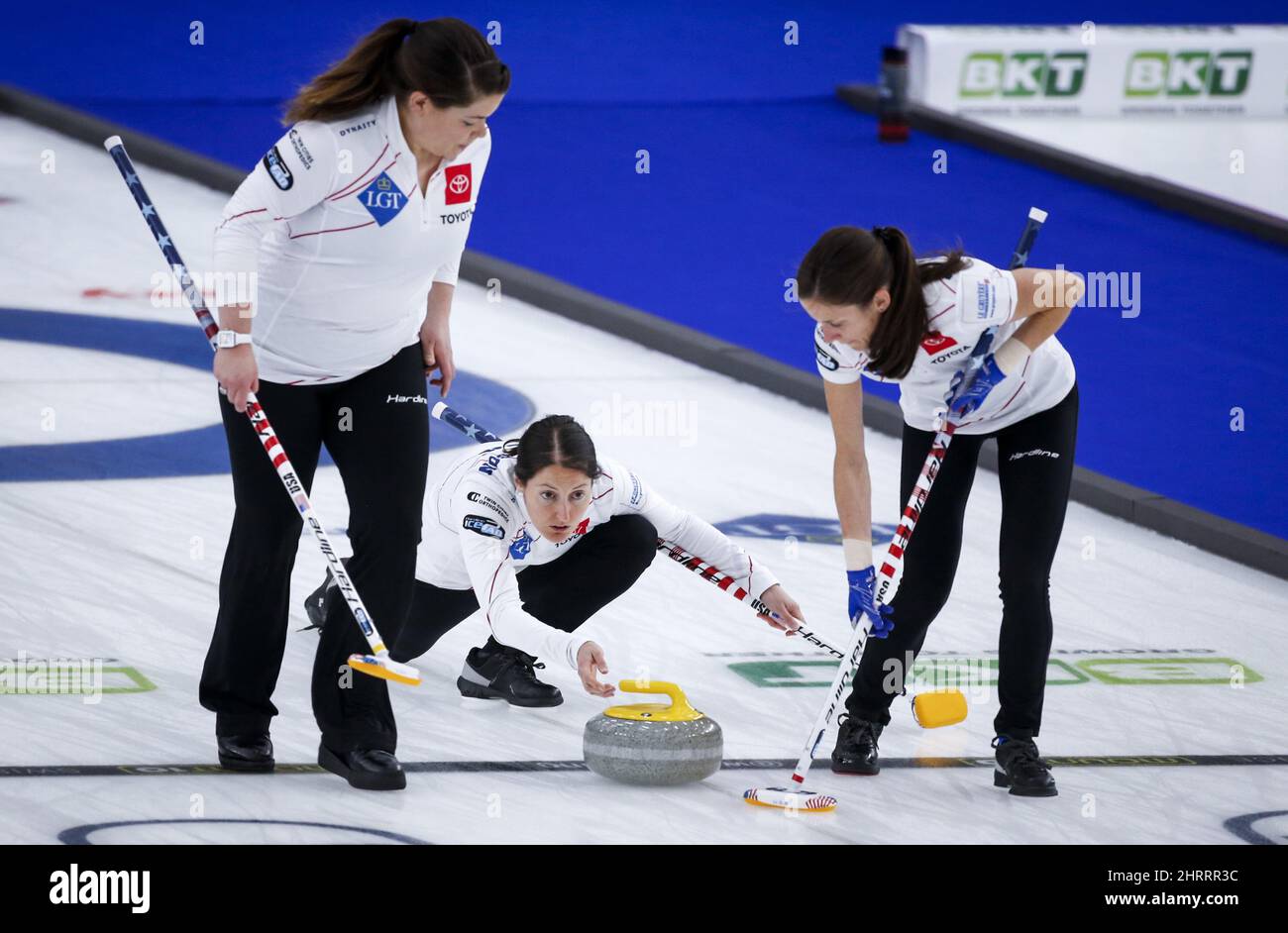 United States skip Tabitha Peterson, centre, makes a shot as lead Tara ...