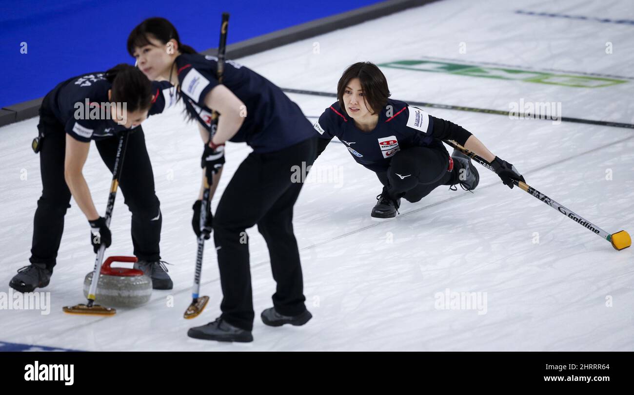 Japan skip Sayaka Yoshimura, right, makes a shot as second Anna Ohmiya ...