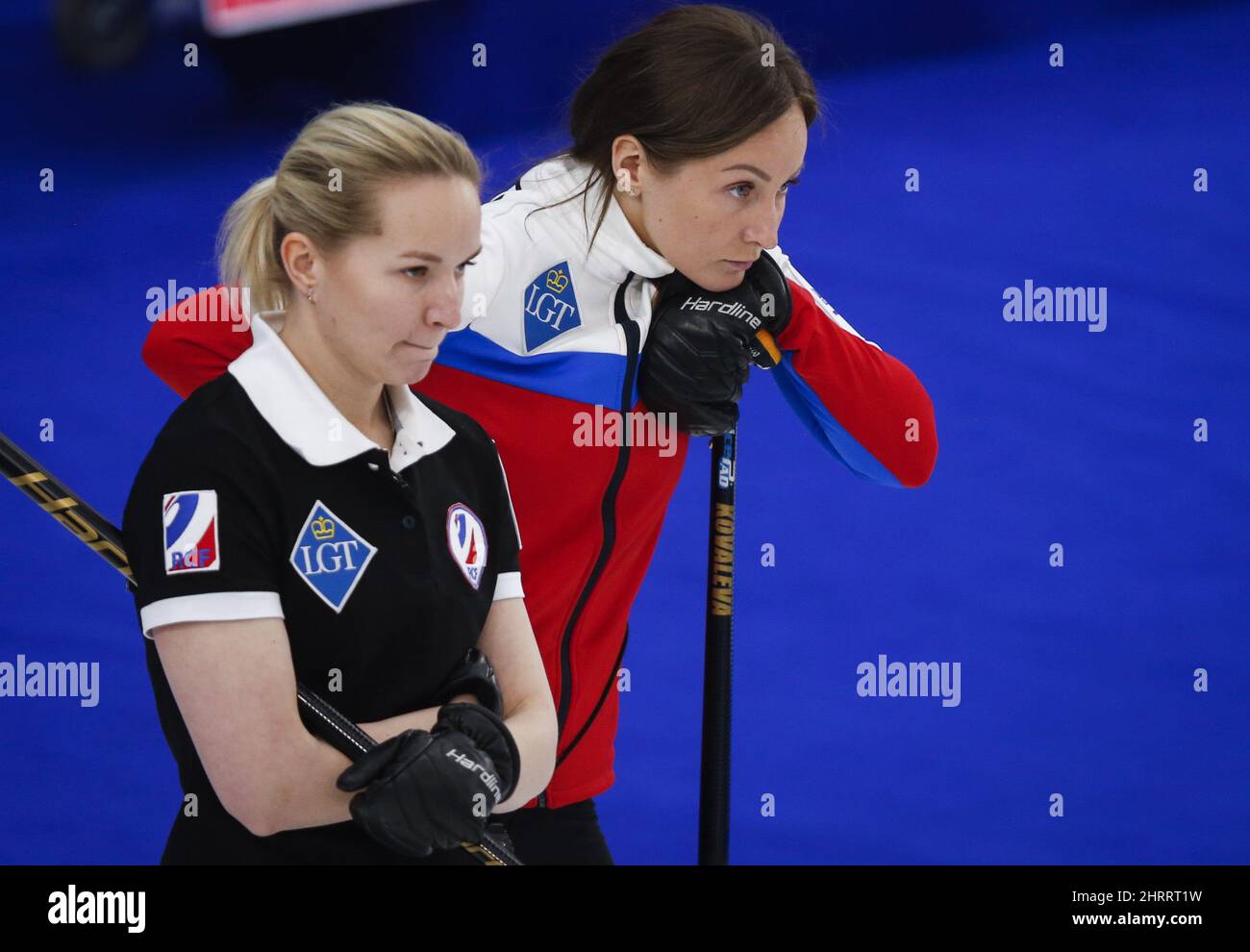 Russia skip Alina Kovaleva, right, and third Julia Portunova look on as ...