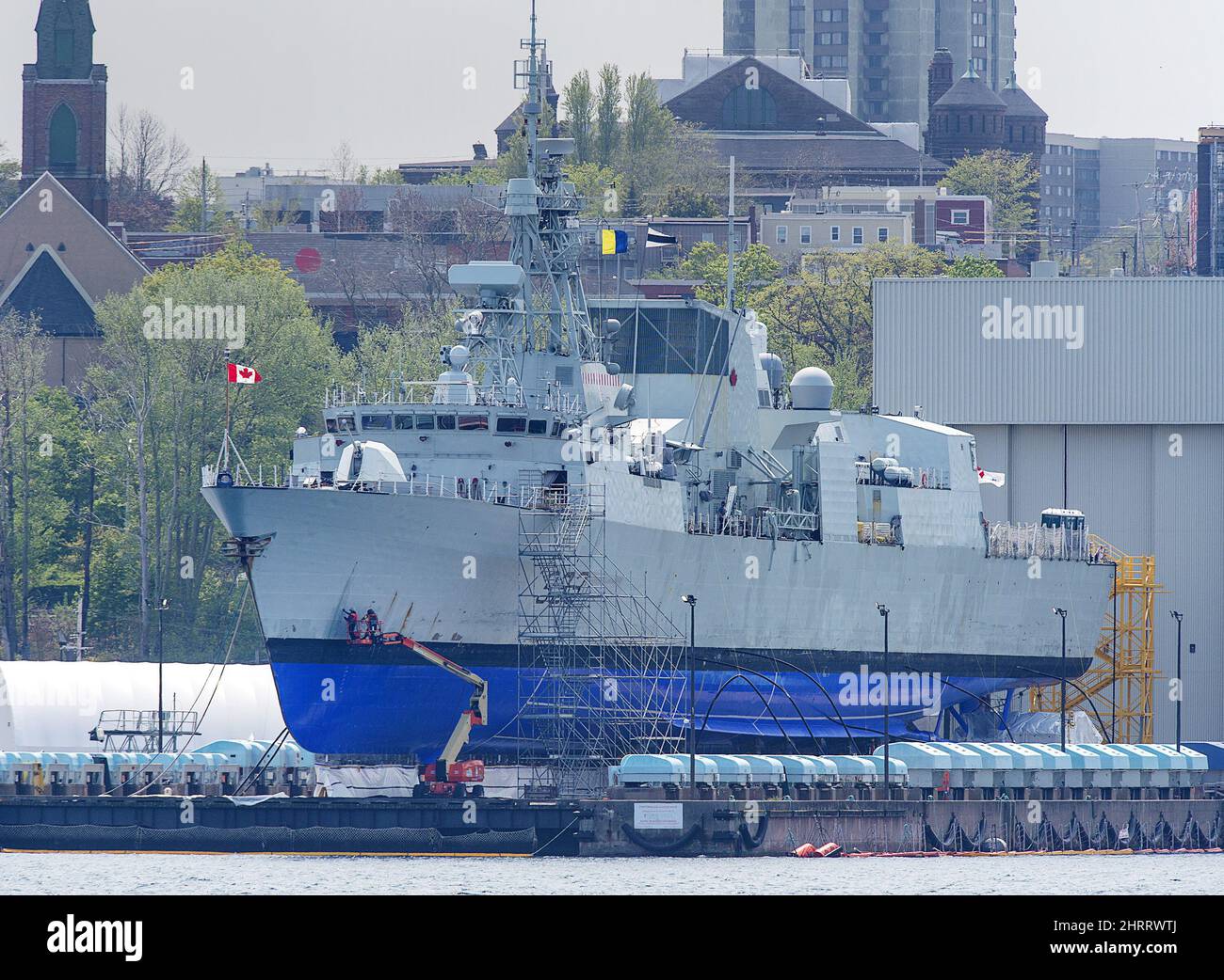 Technicians work on the hull of HMCS Toronto at the fleet maintenance ...