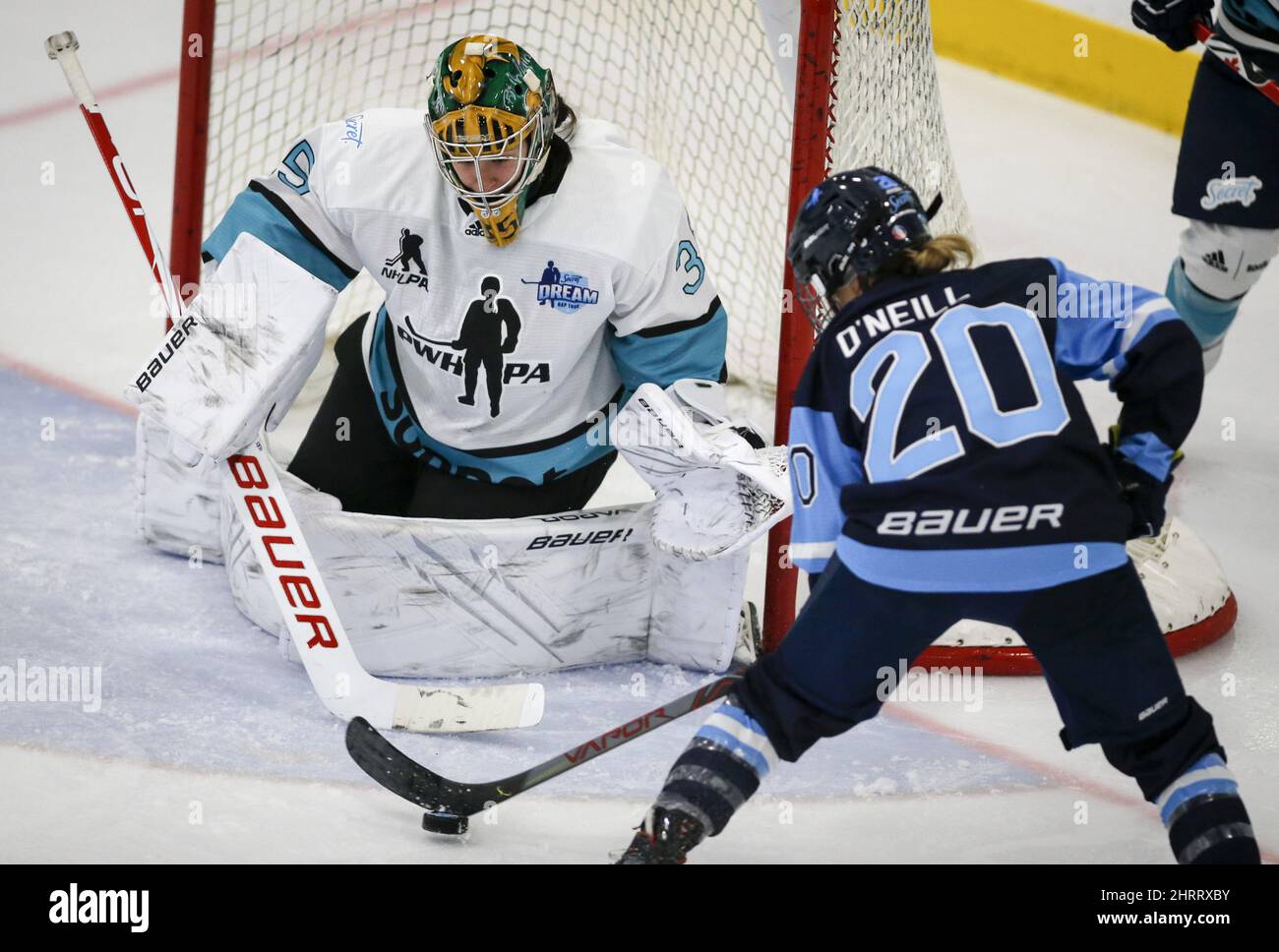 Team Bauer Kristin O'Neill, right, tries to get the puck past Team ...