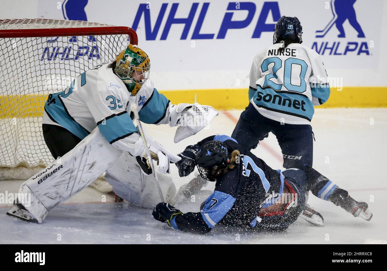 Team Bauer Laura Stacey, centre, crashes into Team Sonnet goalie Shea ...