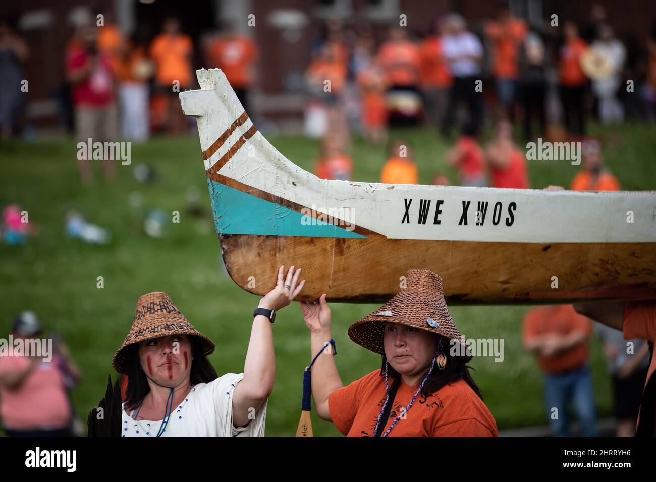 Women from the Sto:lo Nation carry a canoe after a ceremony to lead ...