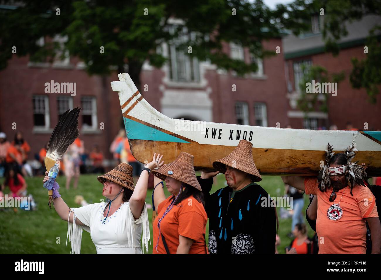 People from the Sto:lo Nation carry a canoe after a ceremony to lead ...