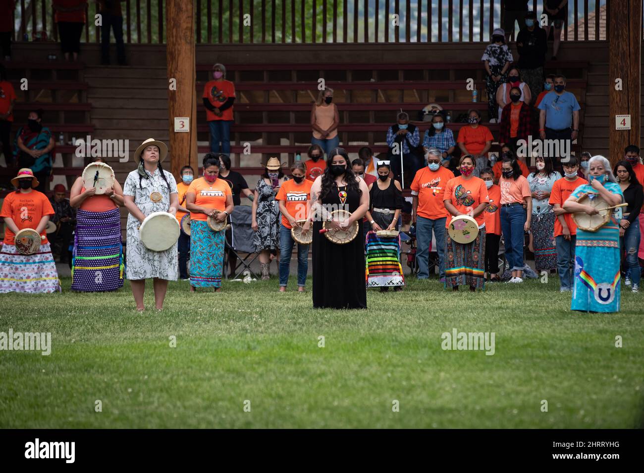 People pause during a moment of silence near the former Kamloops Indian ...