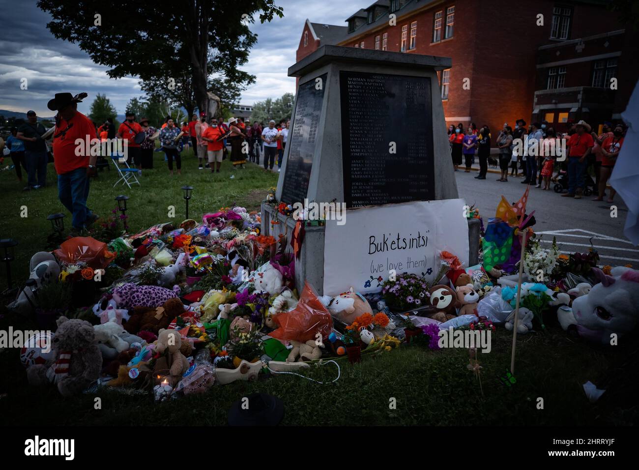 People sing and drum at a memorial outside the former Kamloops Indian ...