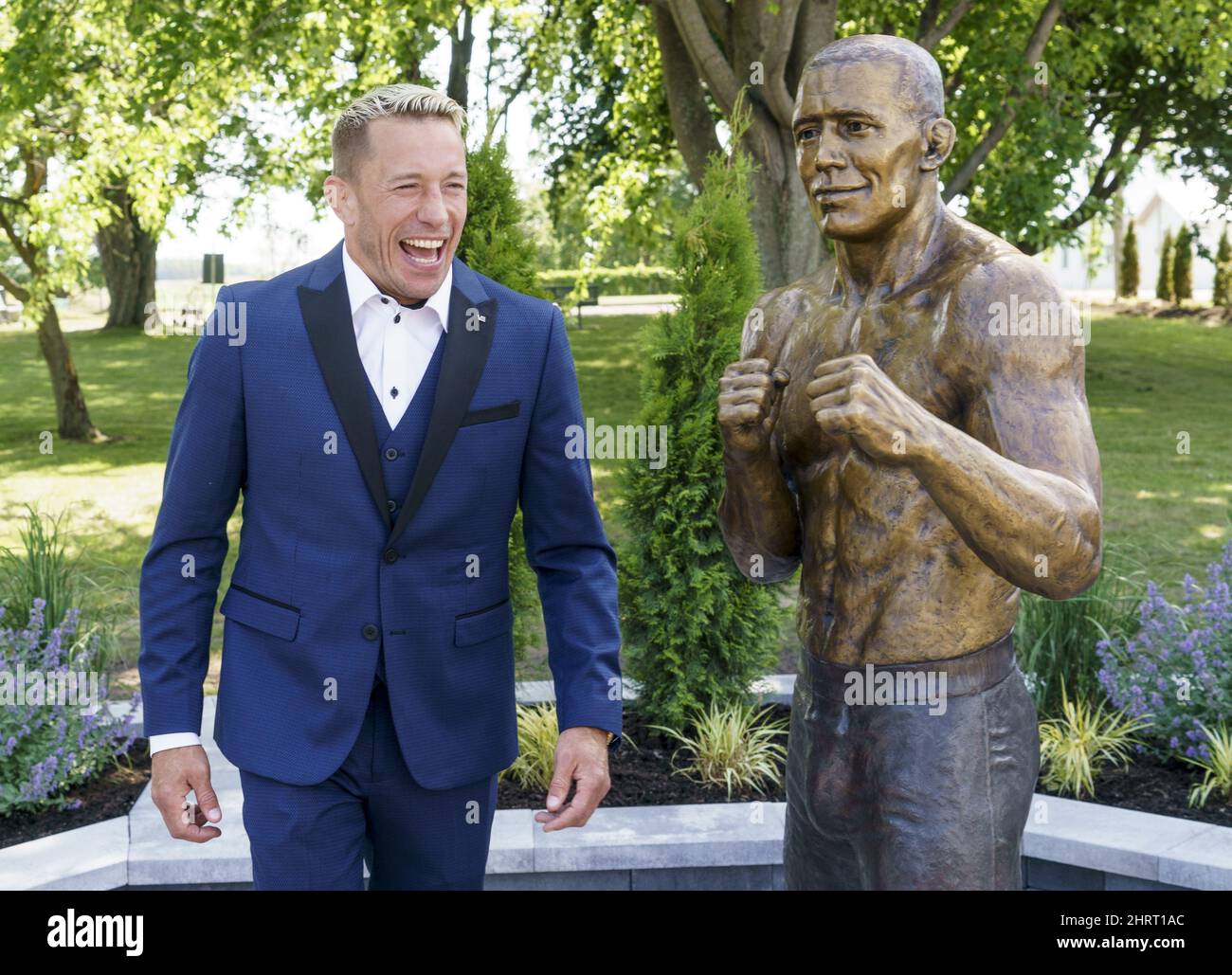 Mixed martial arts champion Georges St-Pierre laughs after unveiling a ...