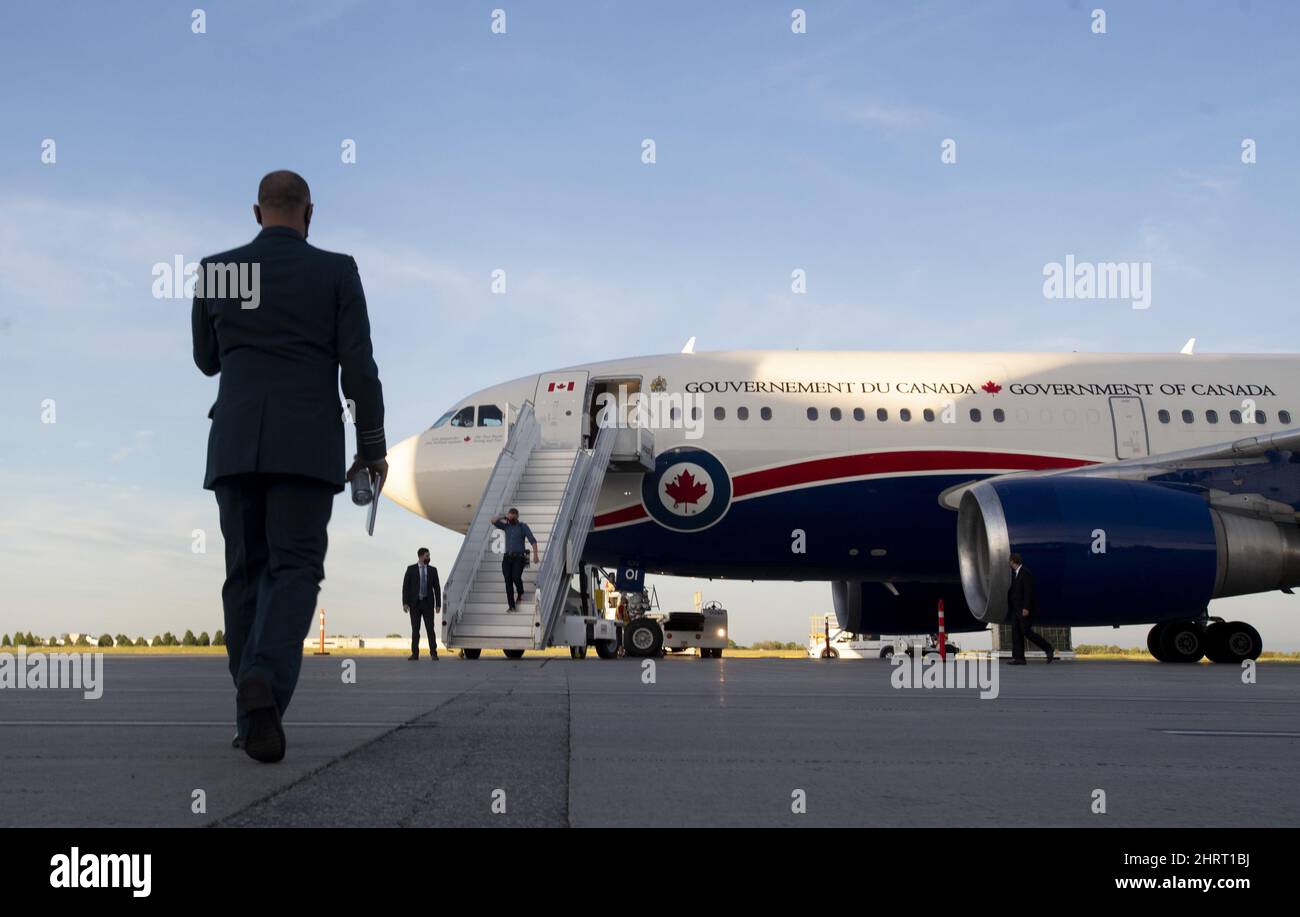 Flight crew make their way to a Canadian Forces plane as they wait for ...